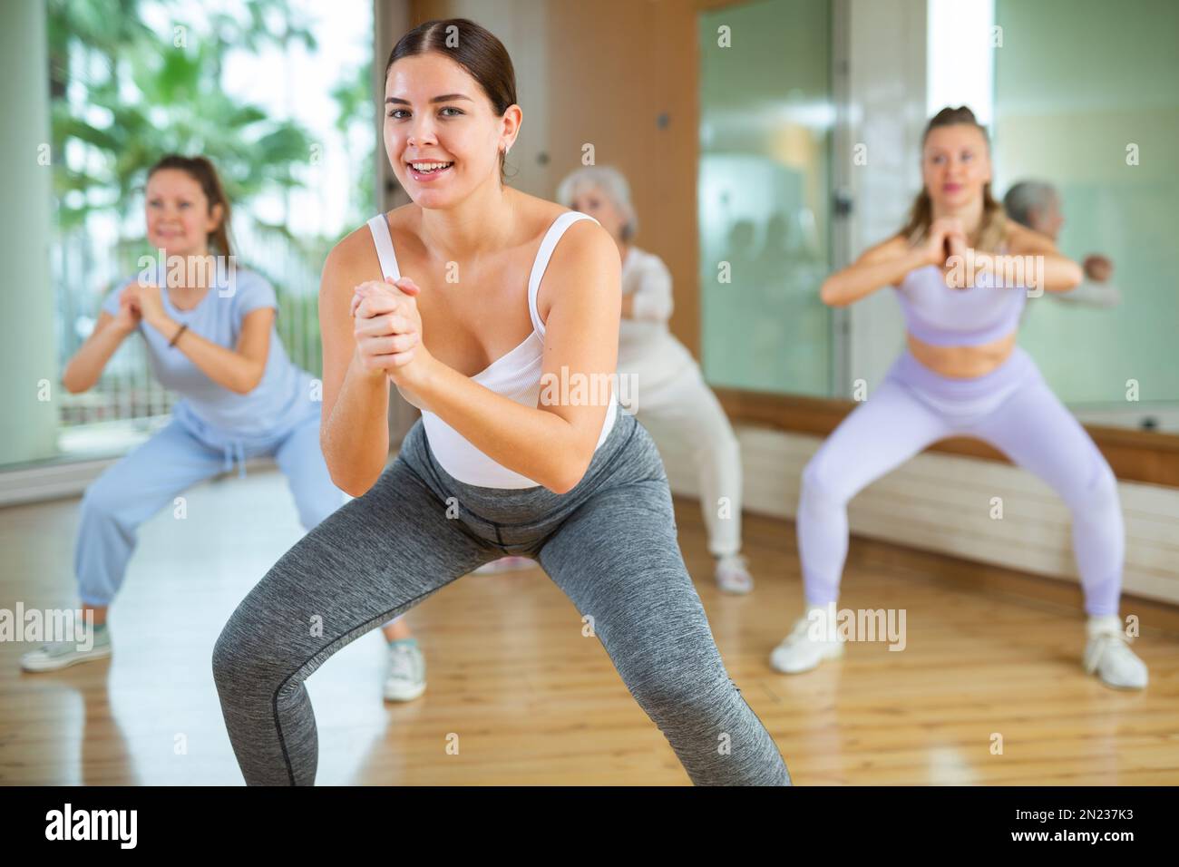 Group are practising arch movement in step jazz dance in fitness gym ...