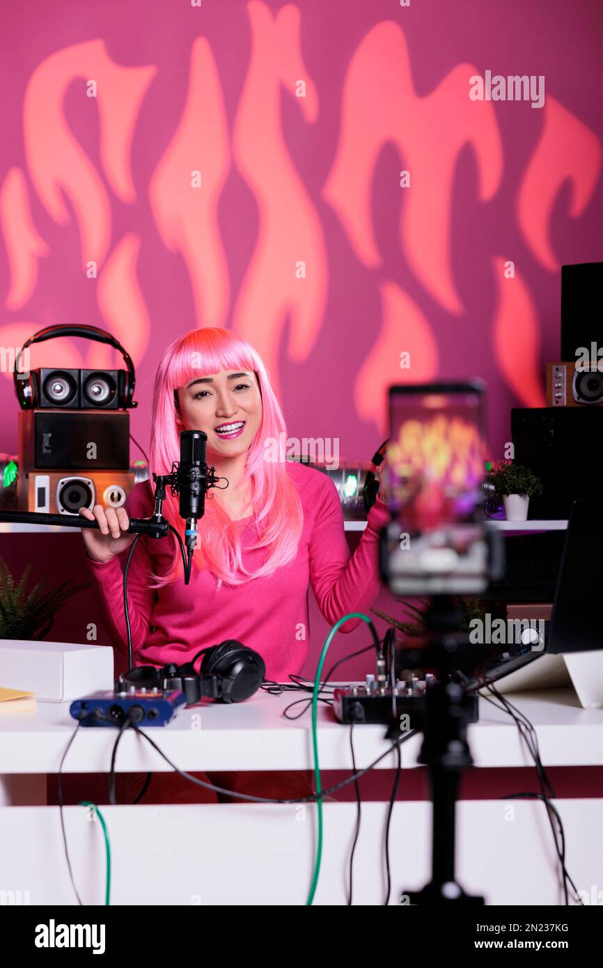 Female vlogger using microphone headphones hi-res stock photography and ...