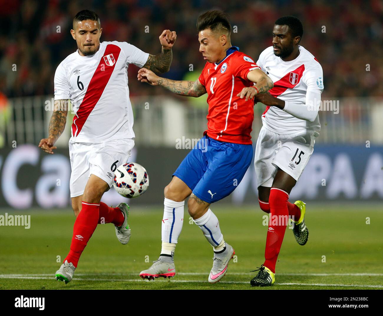 Chile's Eduardo Vargas, center, vies for the ball against Peru's Juan ...