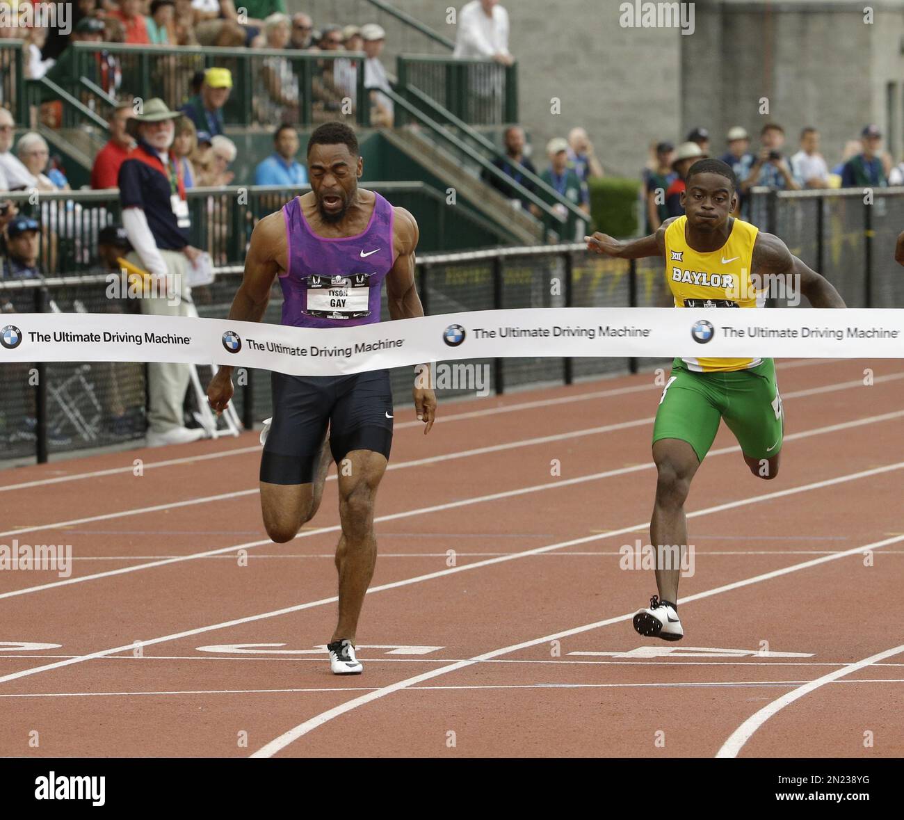 Tyson Gay, left, hits the tape ahead of Trayvon Bromell to win the 100 ...