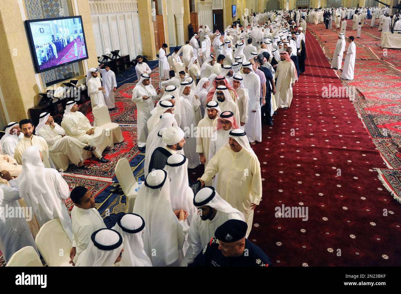 In this Sunday, June 28, 2015 photo, Kuwaitis queue at the Grand Mosque ...