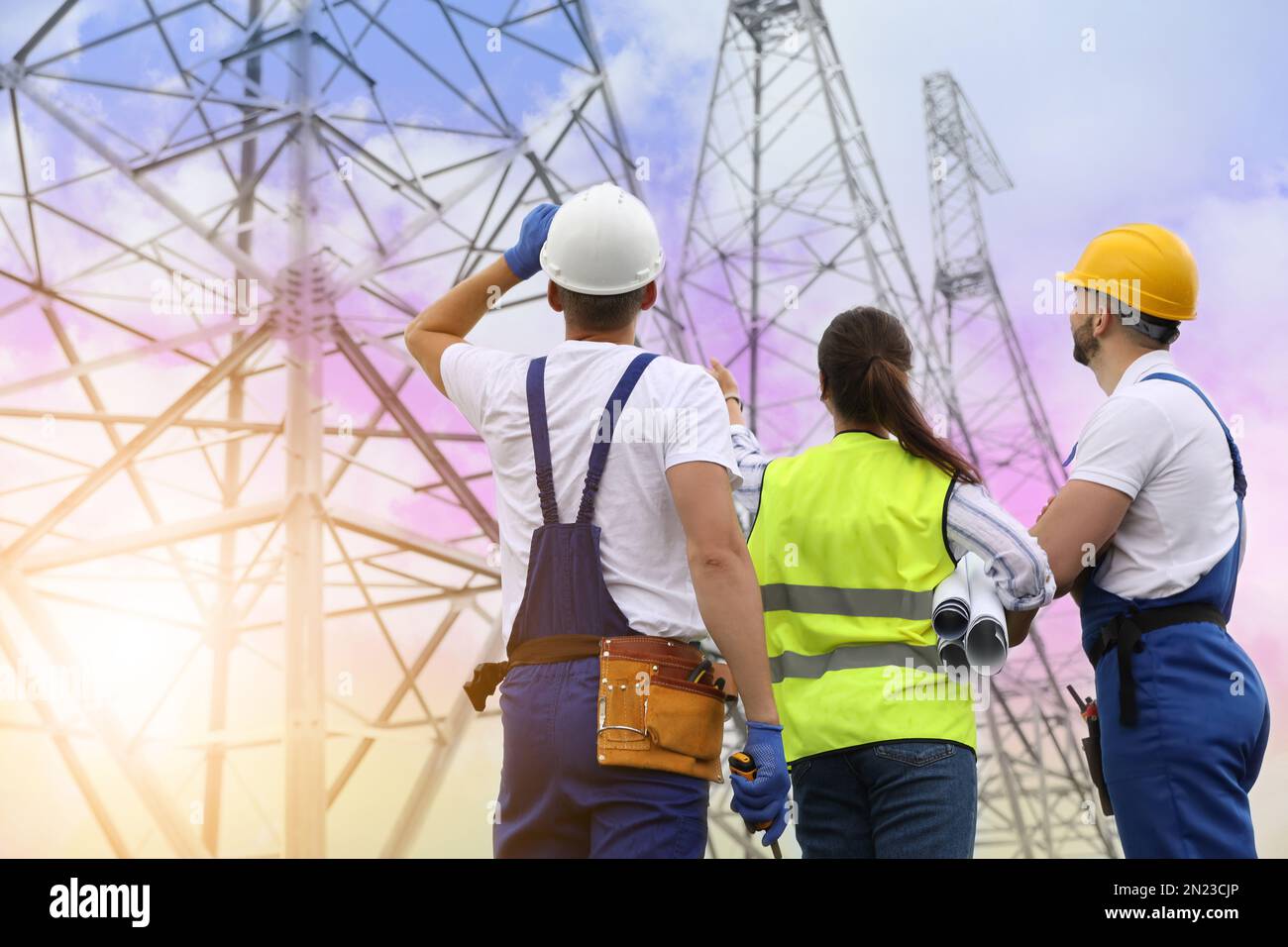 Professional engineers working on installation of electrical substation ...