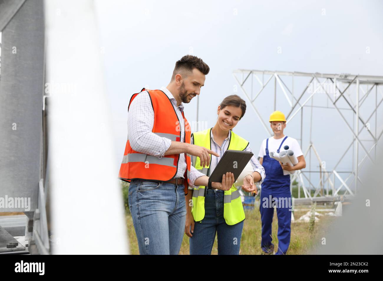 Professional engineers working on installation of electrical substation ...