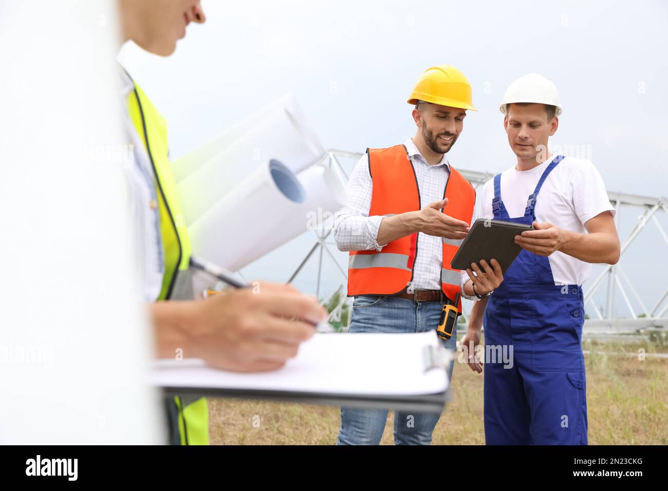 Professional engineers working on installation of electrical substation ...