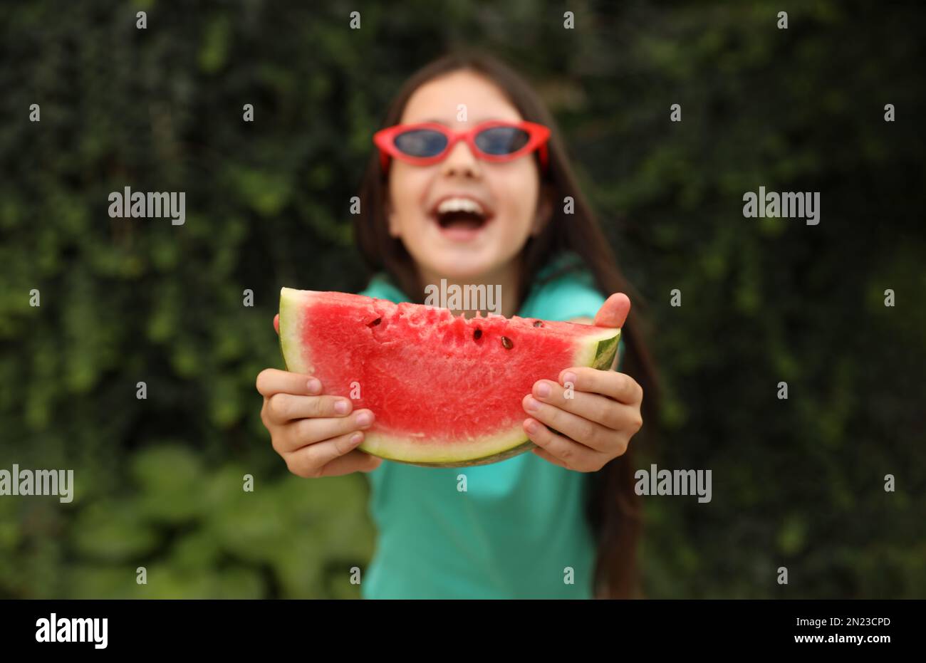 Cute little girl outdoors, focus on hands with watermelon Stock Photo ...