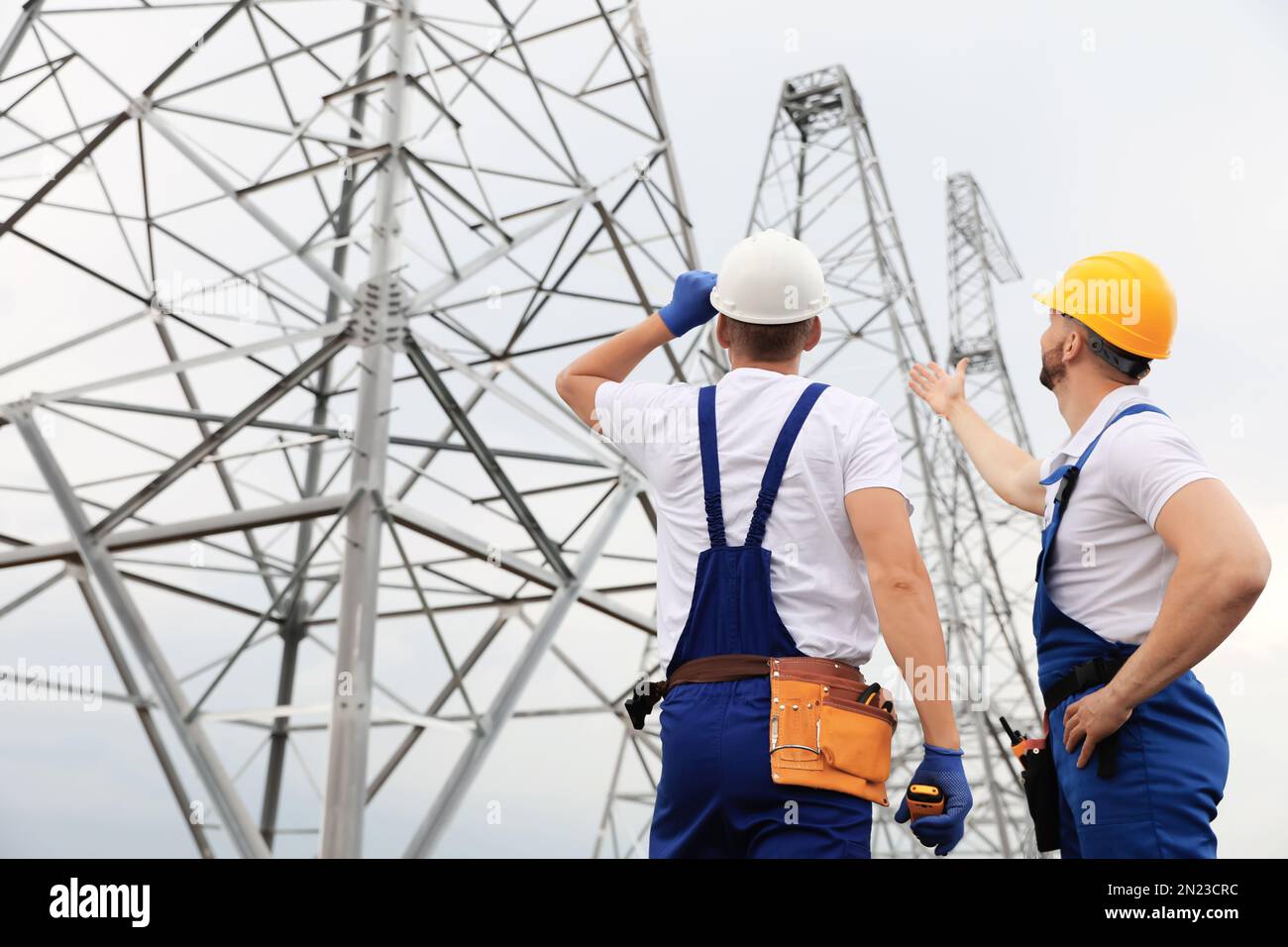 Professional engineers working on installation of electrical substation ...