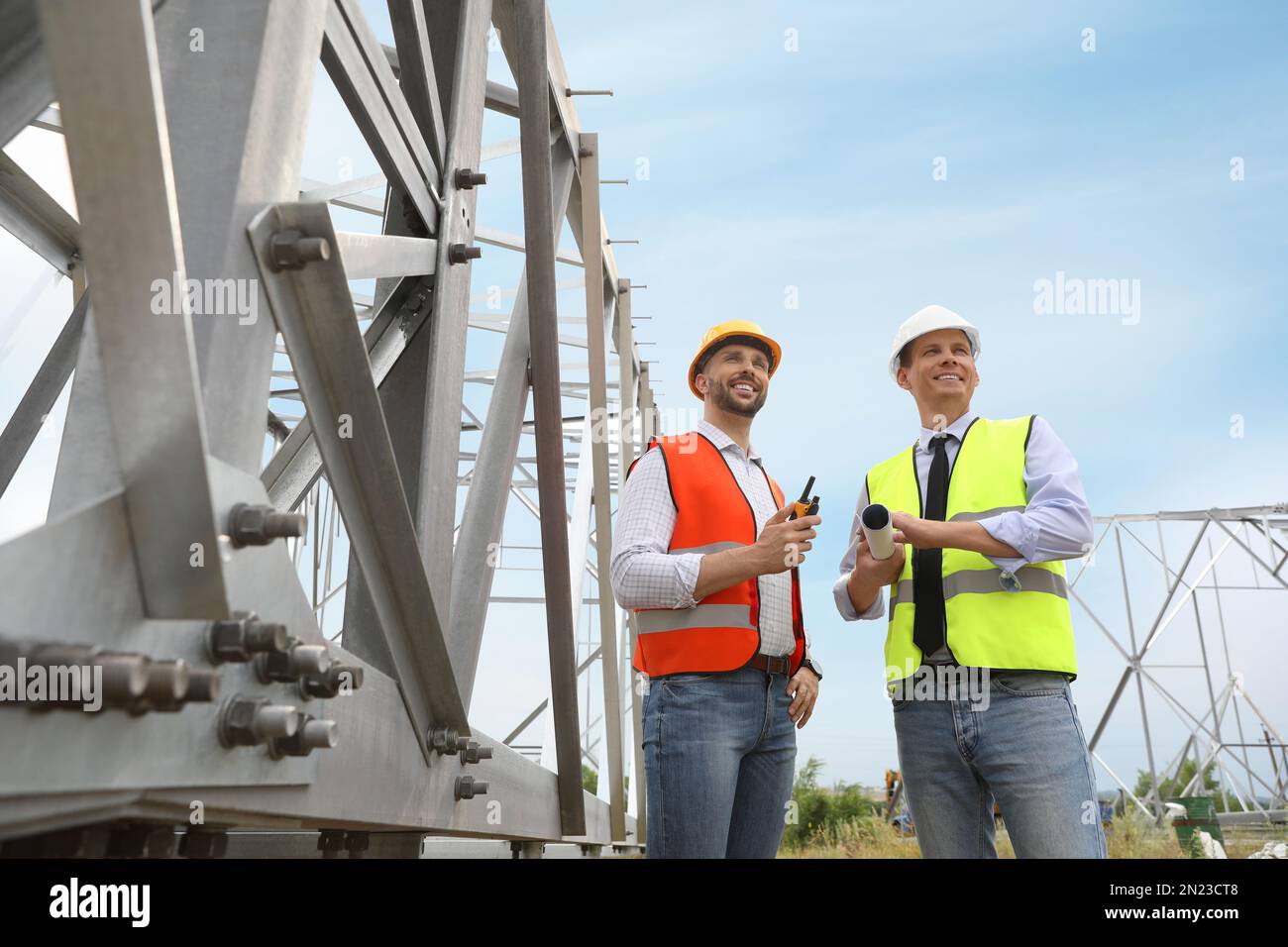 Professional engineers working on installation of electrical substation ...