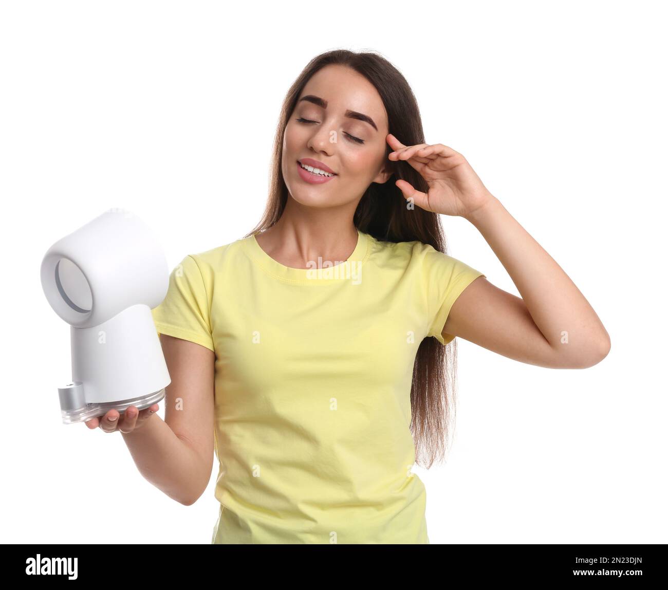 Woman enjoying air flow from portable fan on white background. Summer ...