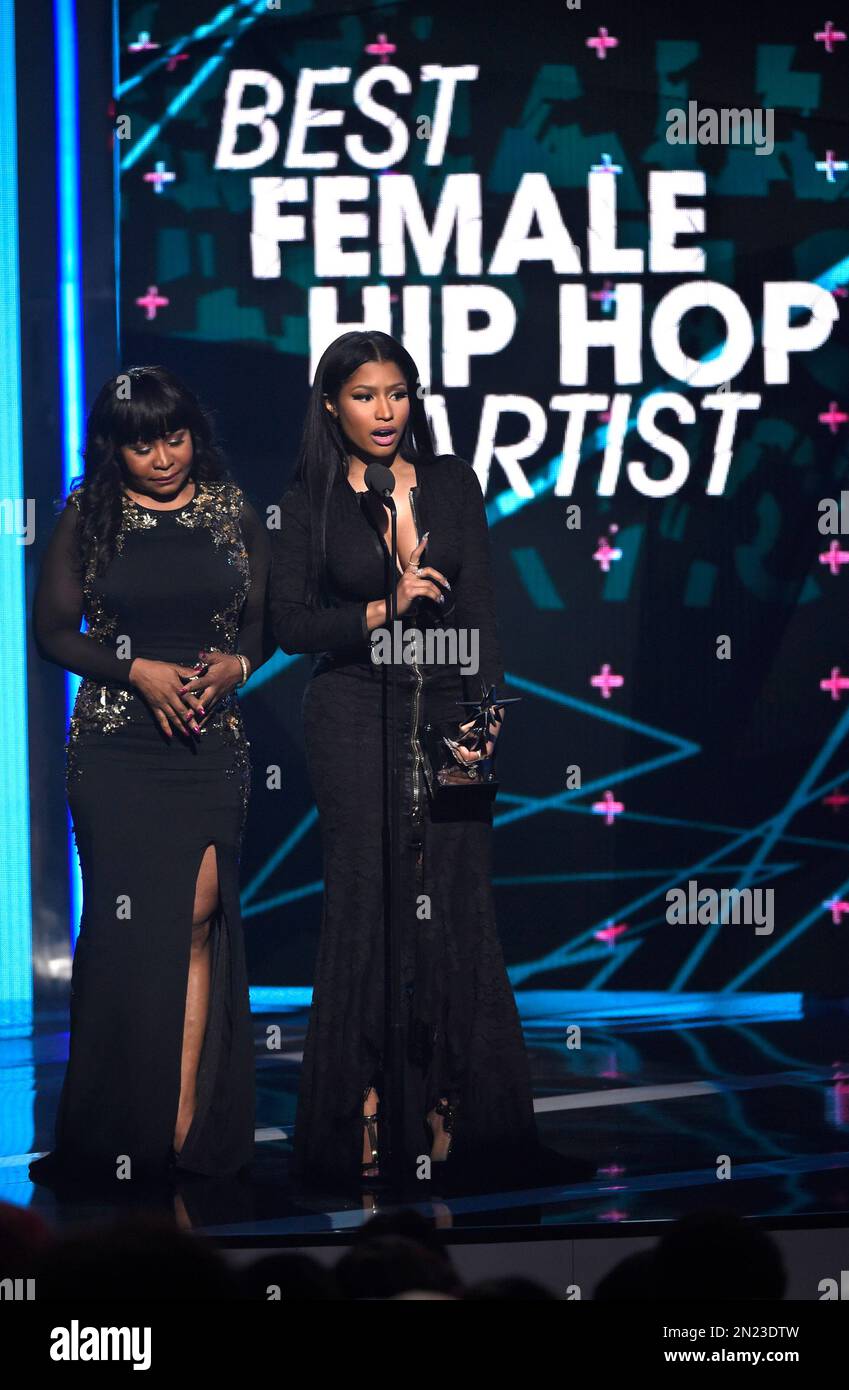 Carol Maraj, left, looks on as Nicki Minaj accepts the award for best ...