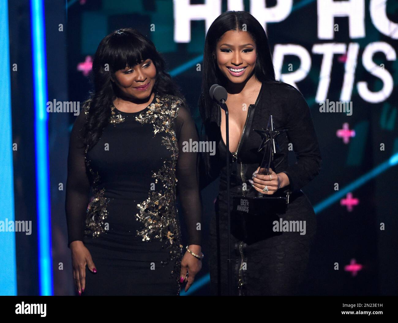 Carol Maraj, left, looks on as Nicki Minaj accepts the award for best ...