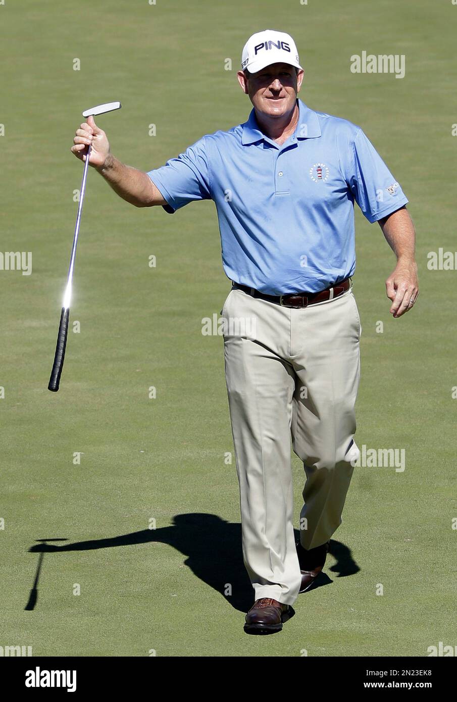 Jeff Maggert raises his putter after sinking his putt on the 18th hole ...
