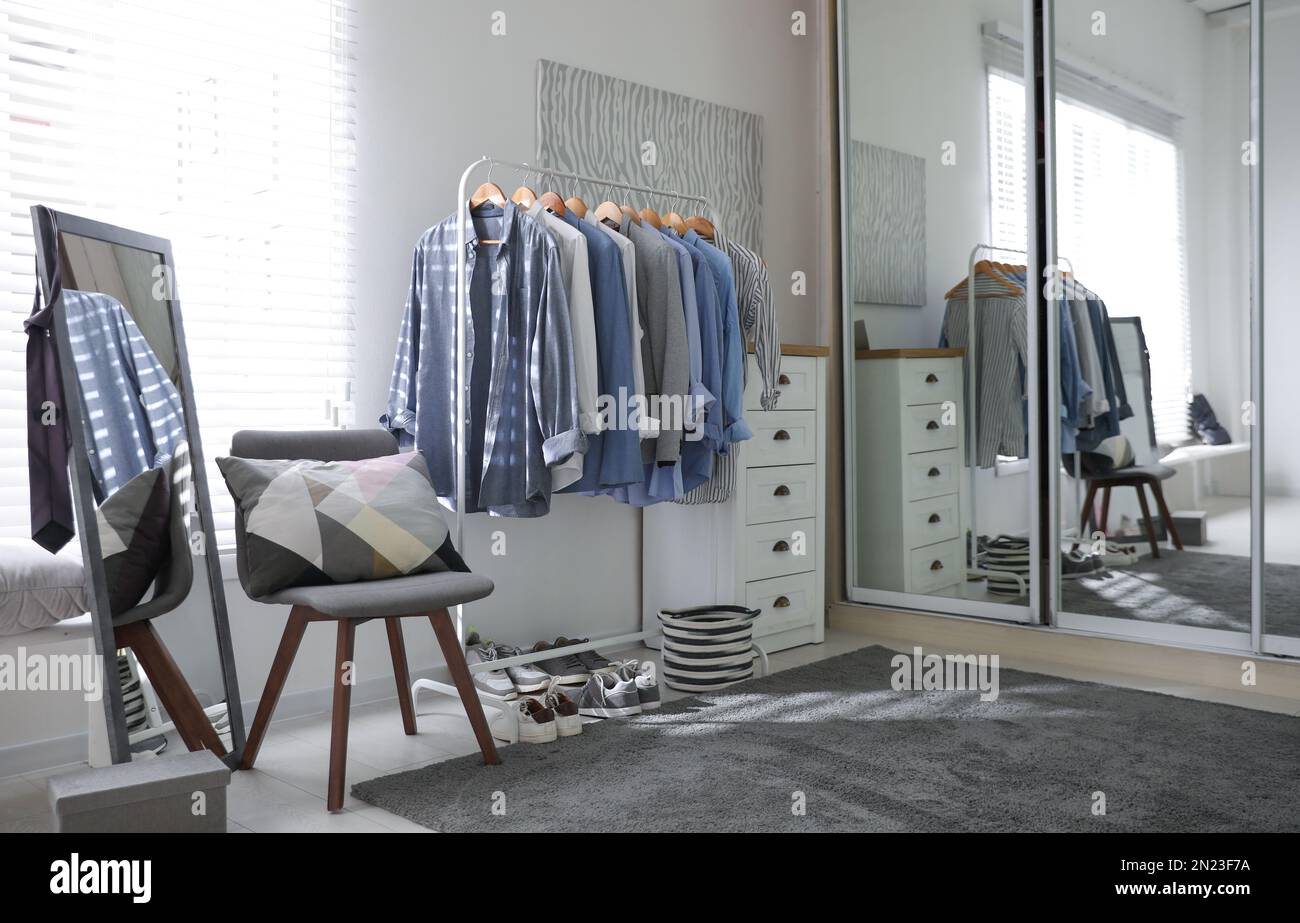 Dressing room interior with clothing rack and mirror Stock Photo - Alamy