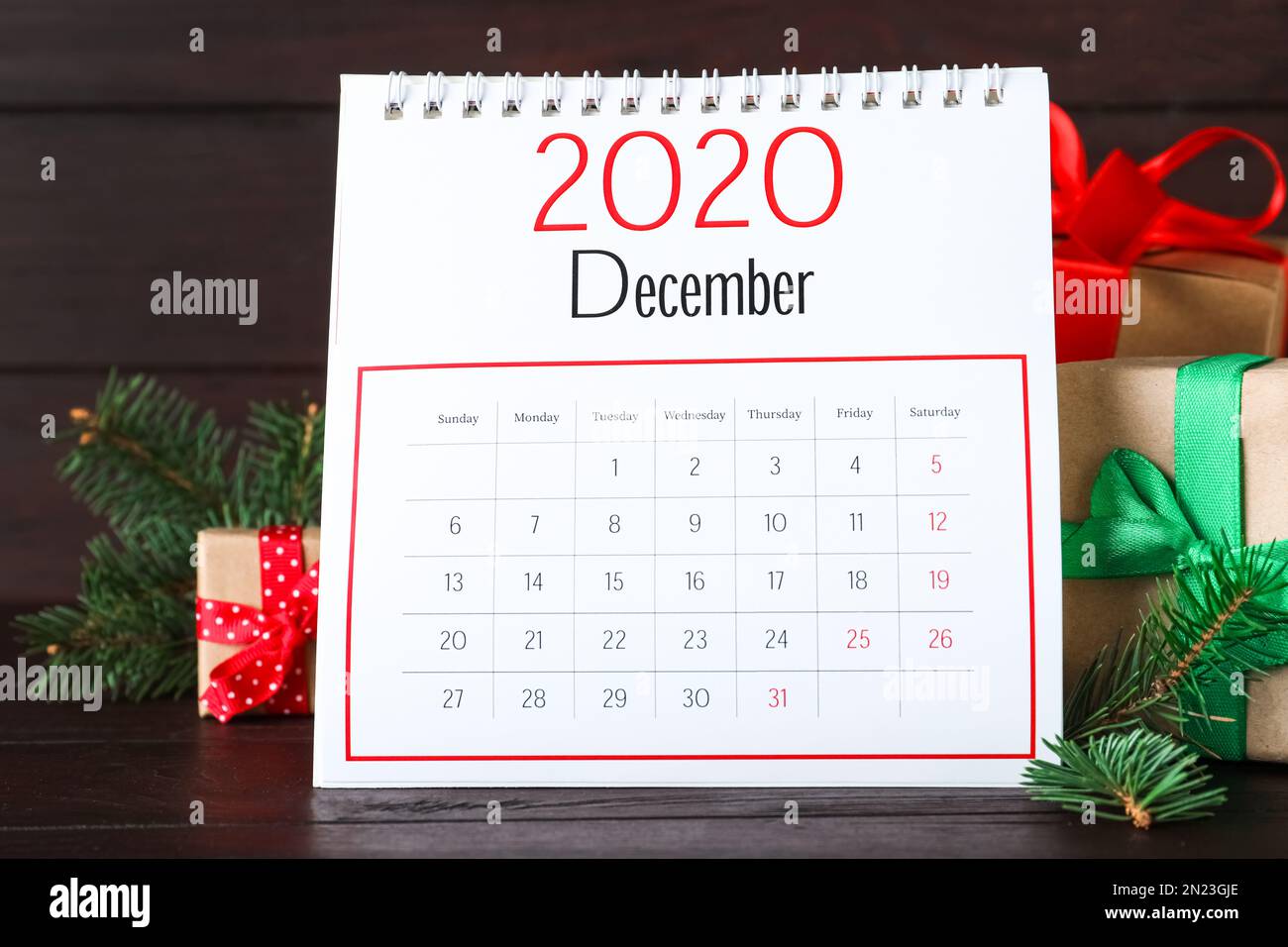 Flip calendar and Christmas decor on brown wooden table. Holiday ...