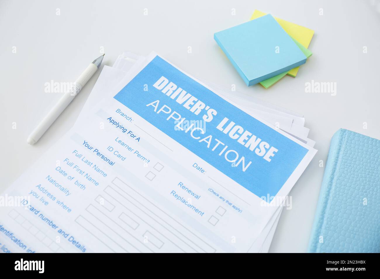 Driver's license application form and stationery on white table Stock Photo - Alamy