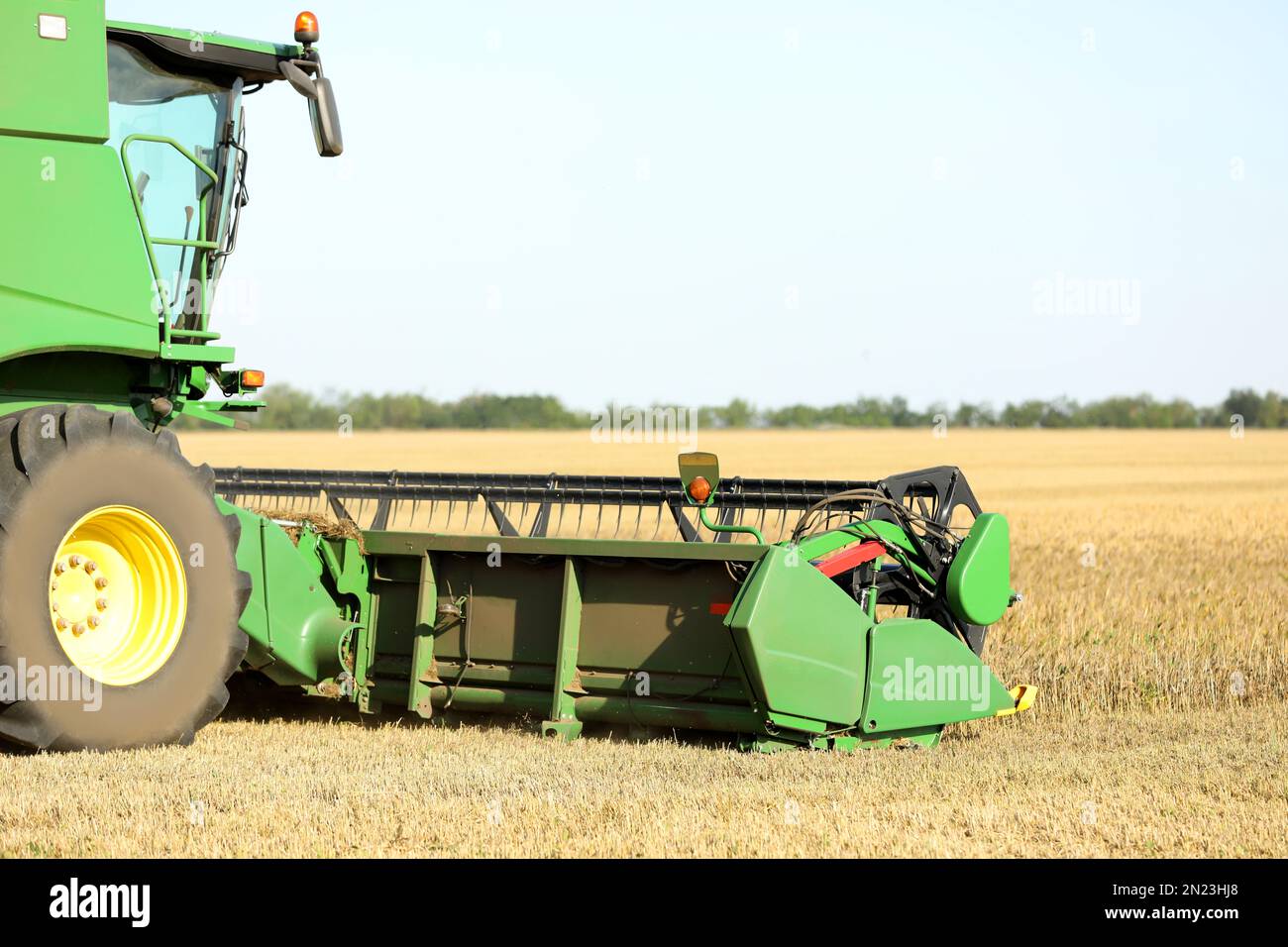 Modern combine harvester working in agricultural field Stock Photo - Alamy