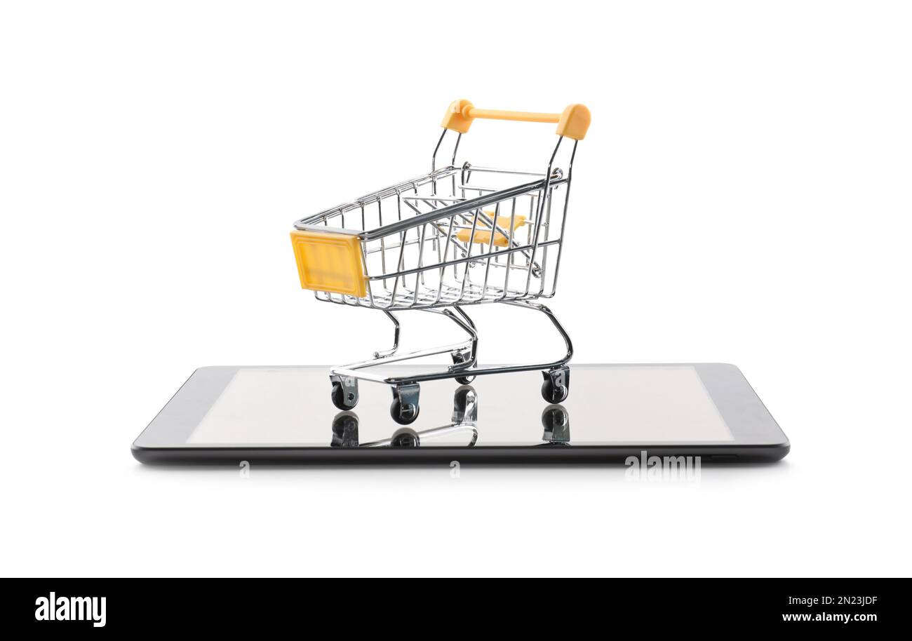 Internet shopping. Small cart and modern tablet on white background ...