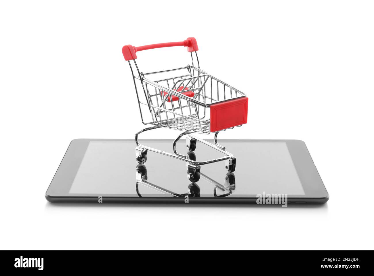 Internet shopping. Small cart and modern tablet on white background ...