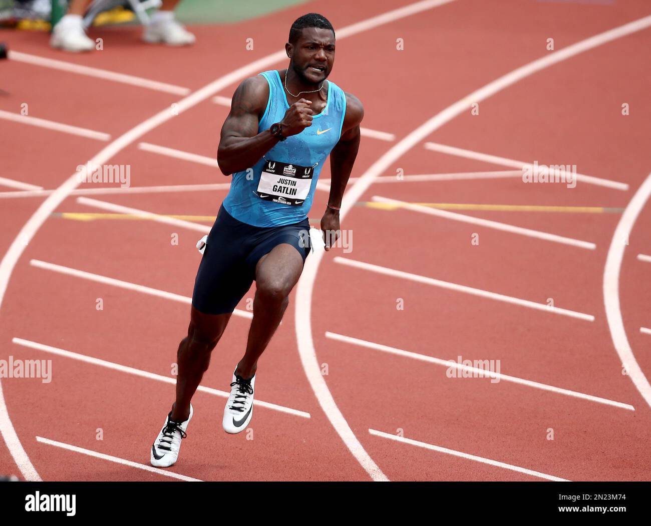 Justin Gatlin turns the corner on his way to winning his preliminary ...