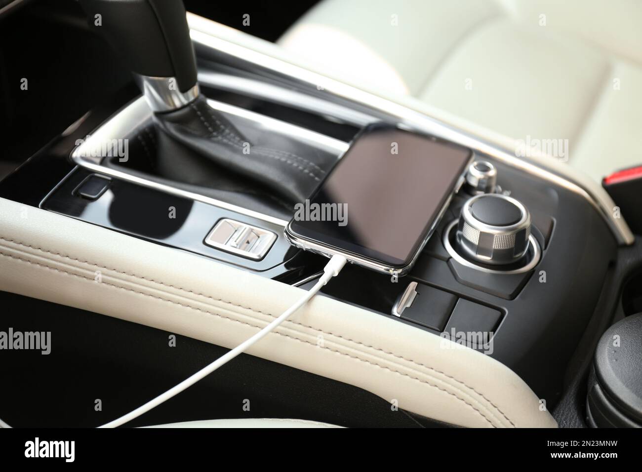 Mobile phone with charging cable in car Stock Photo - Alamy