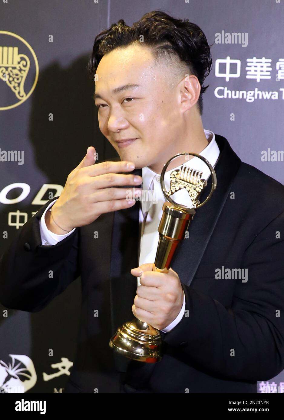 Hong Kong singer Eason Chen holds his award for the Best Male Mandarin Singer at the 26th Golden ...