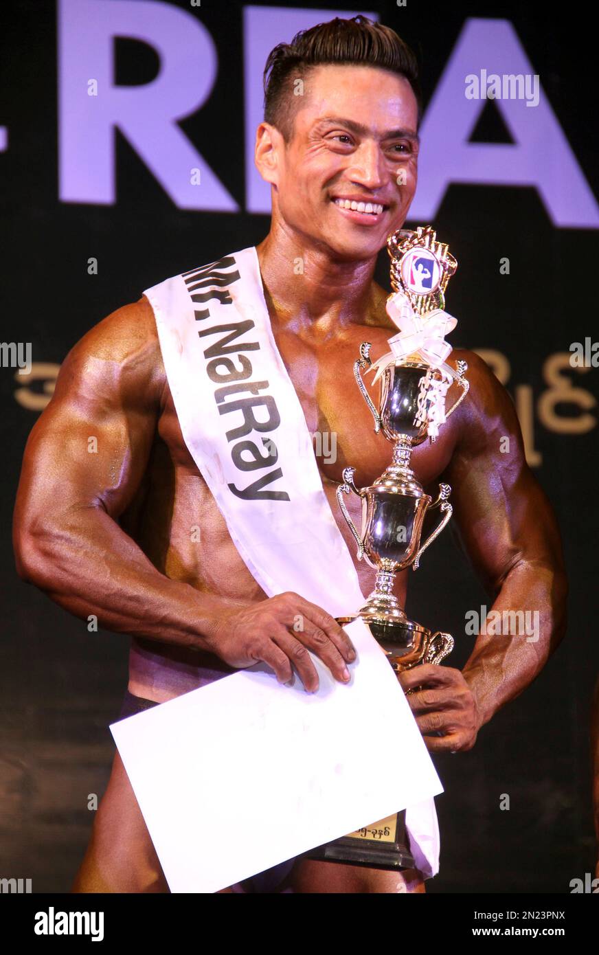 Nyi Phyu, winner of the bodybuilding contest, poses for photo after the ...