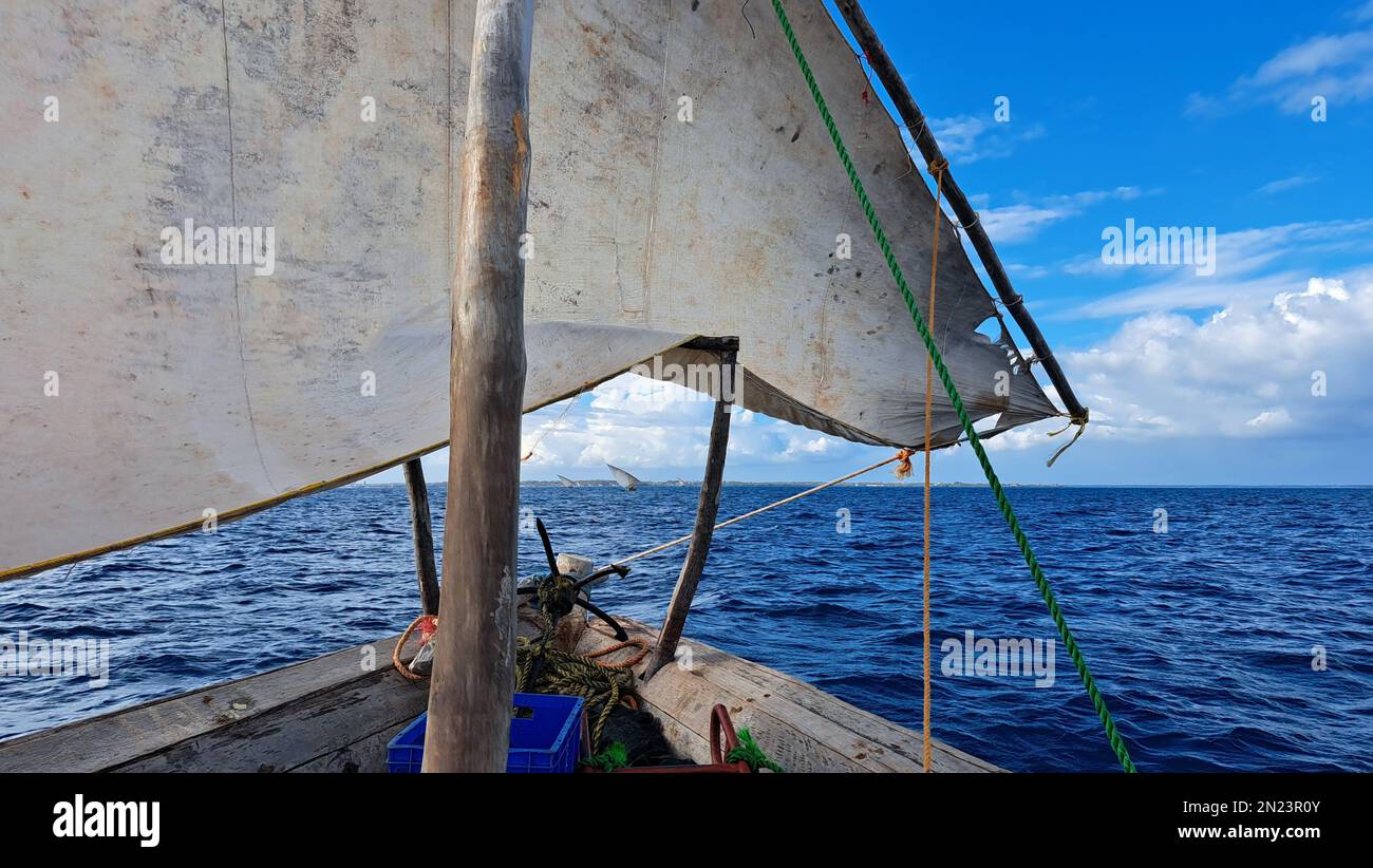 Zanzibar Island, Tanzania dhow boats sailing against a blue sky with ...