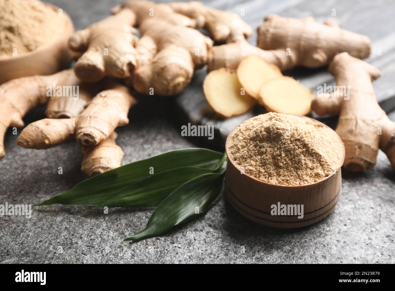 Dry ginger powder, fresh root and leaves on grey table Stock Photo - Alamy