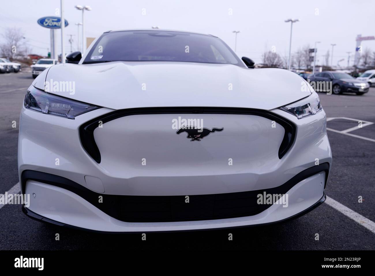 A Ford Mustang Mach-E electric vehicle is displayed at a dealership ...