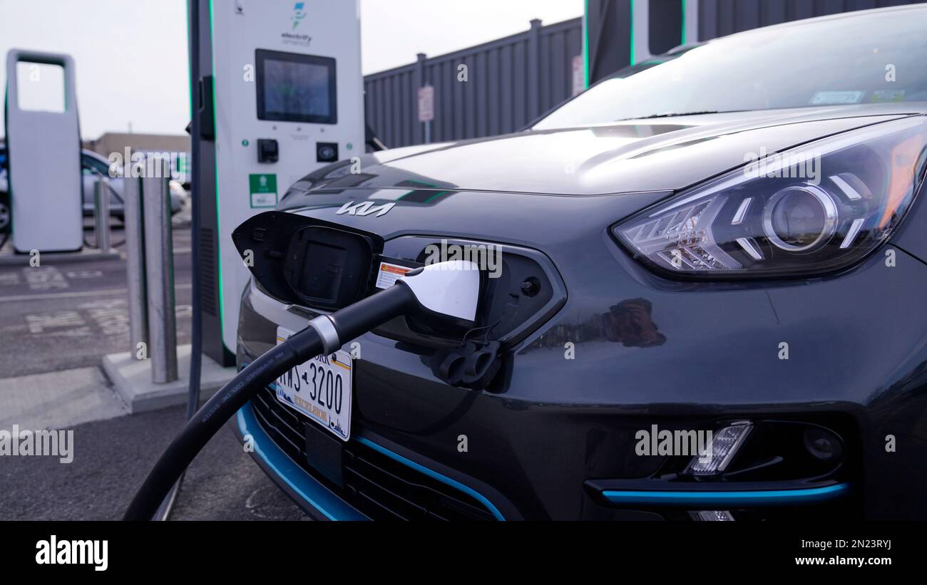 A Kia Nero electric vehicle is charged at an Electrify America EV ...