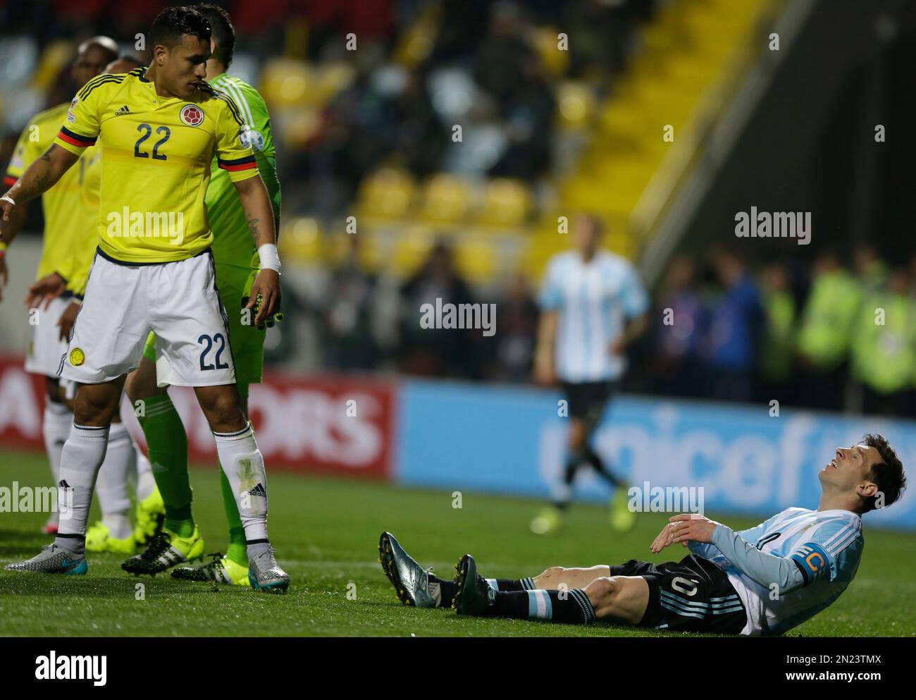 Lionel Messi, ground, gestures as Colombia's Jeison Murillo looks him ...