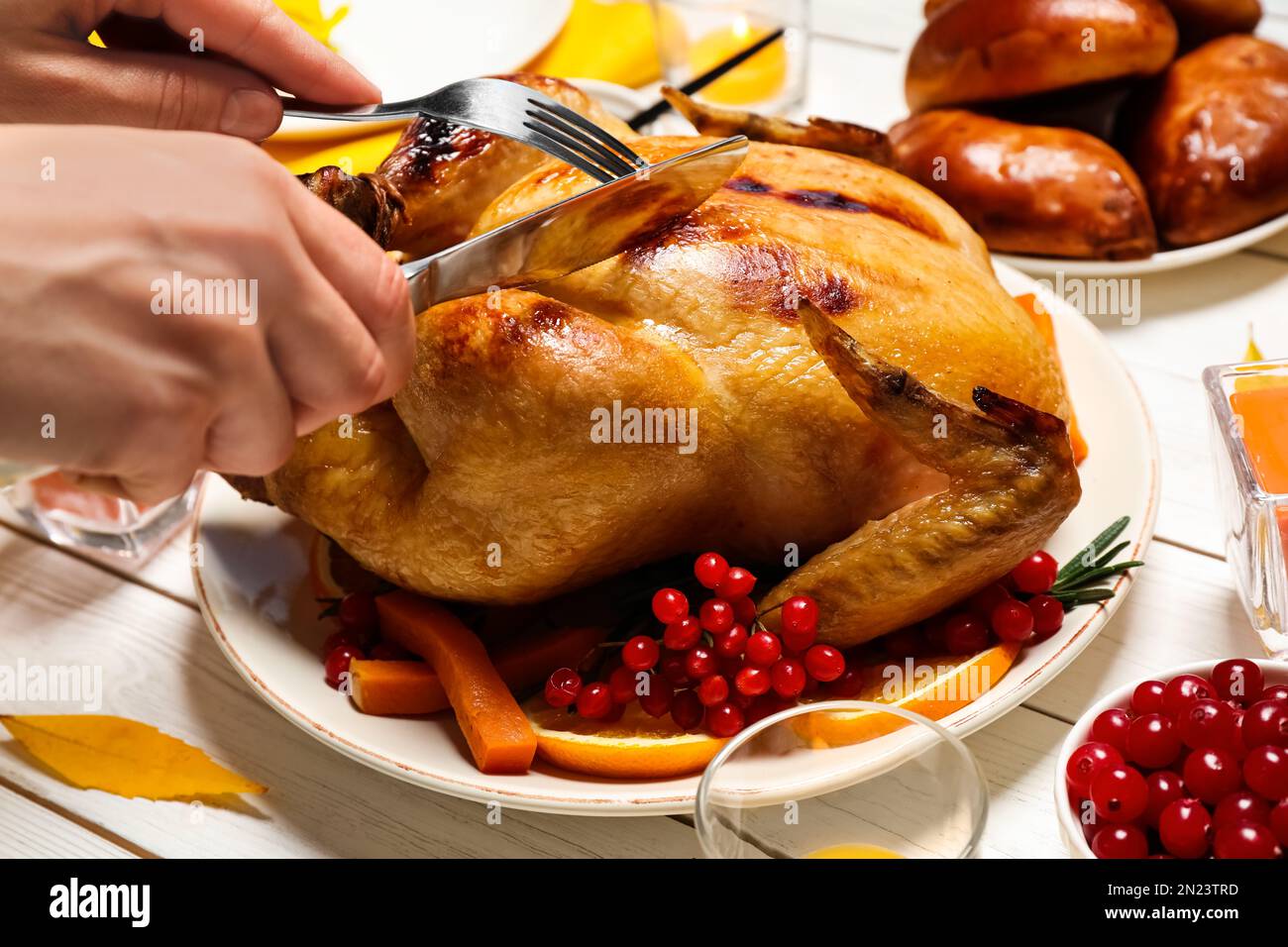 Woman eating traditional cooked turkey at white wooden table, closeup ...