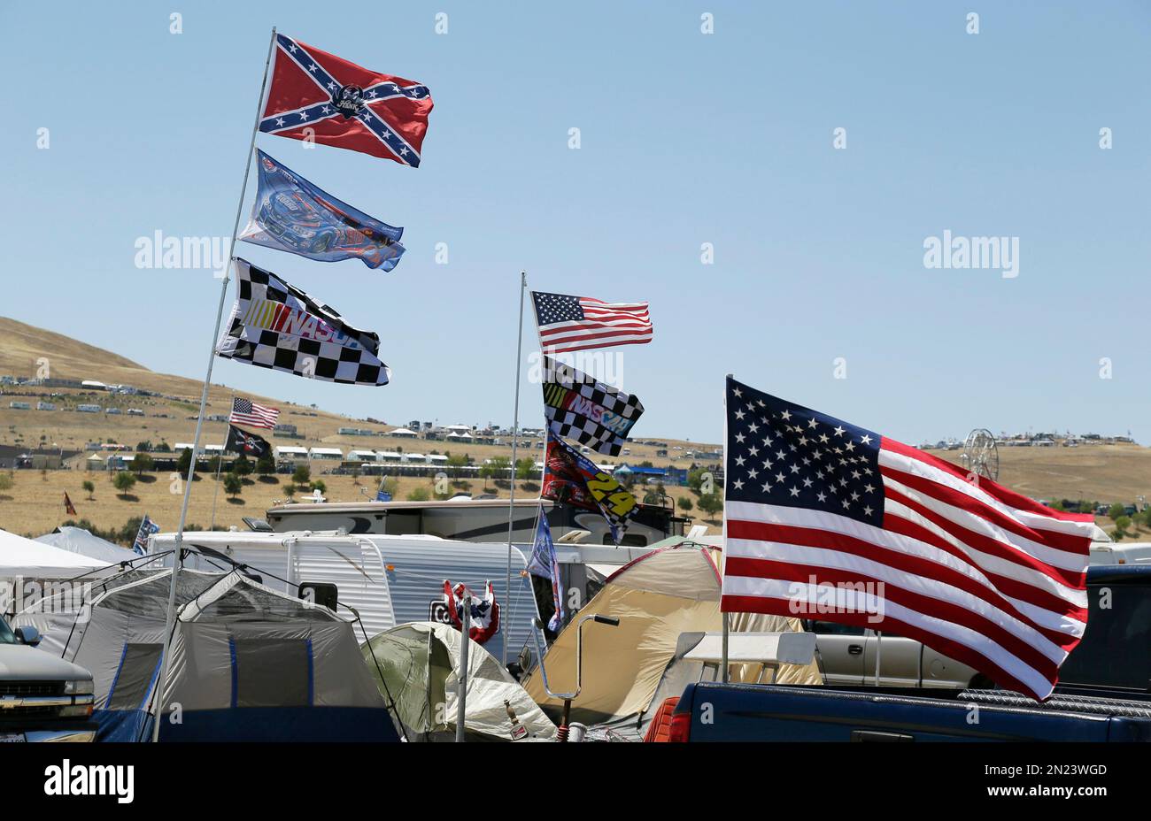 A number of flags, including a Confederate themed one, fly atop RV's in ...