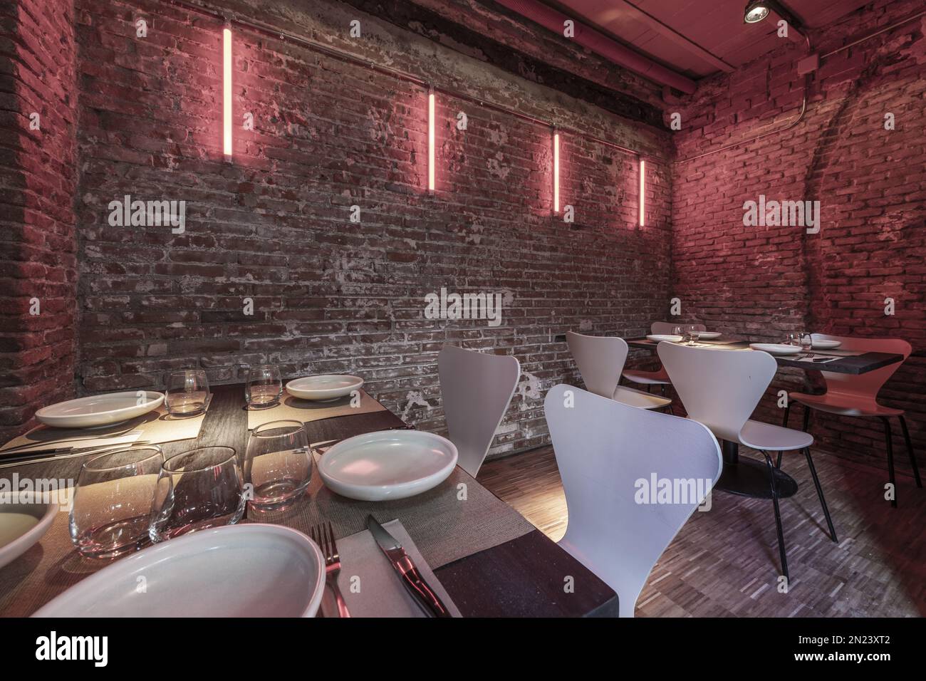 Dining room of a restaurant in a basement with rigid brick and wooden ...