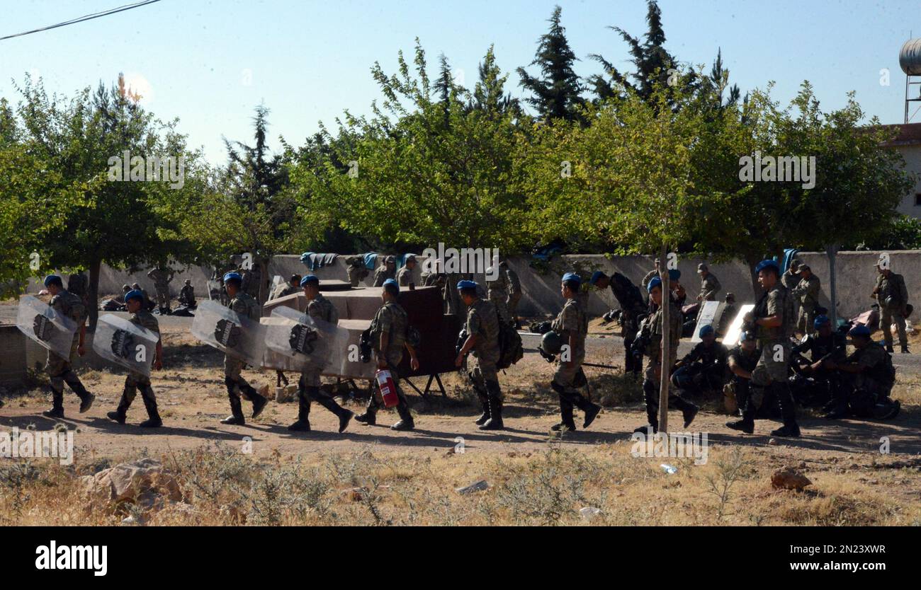 Turkish soldiers walk to their position on the Turkish side of the ...