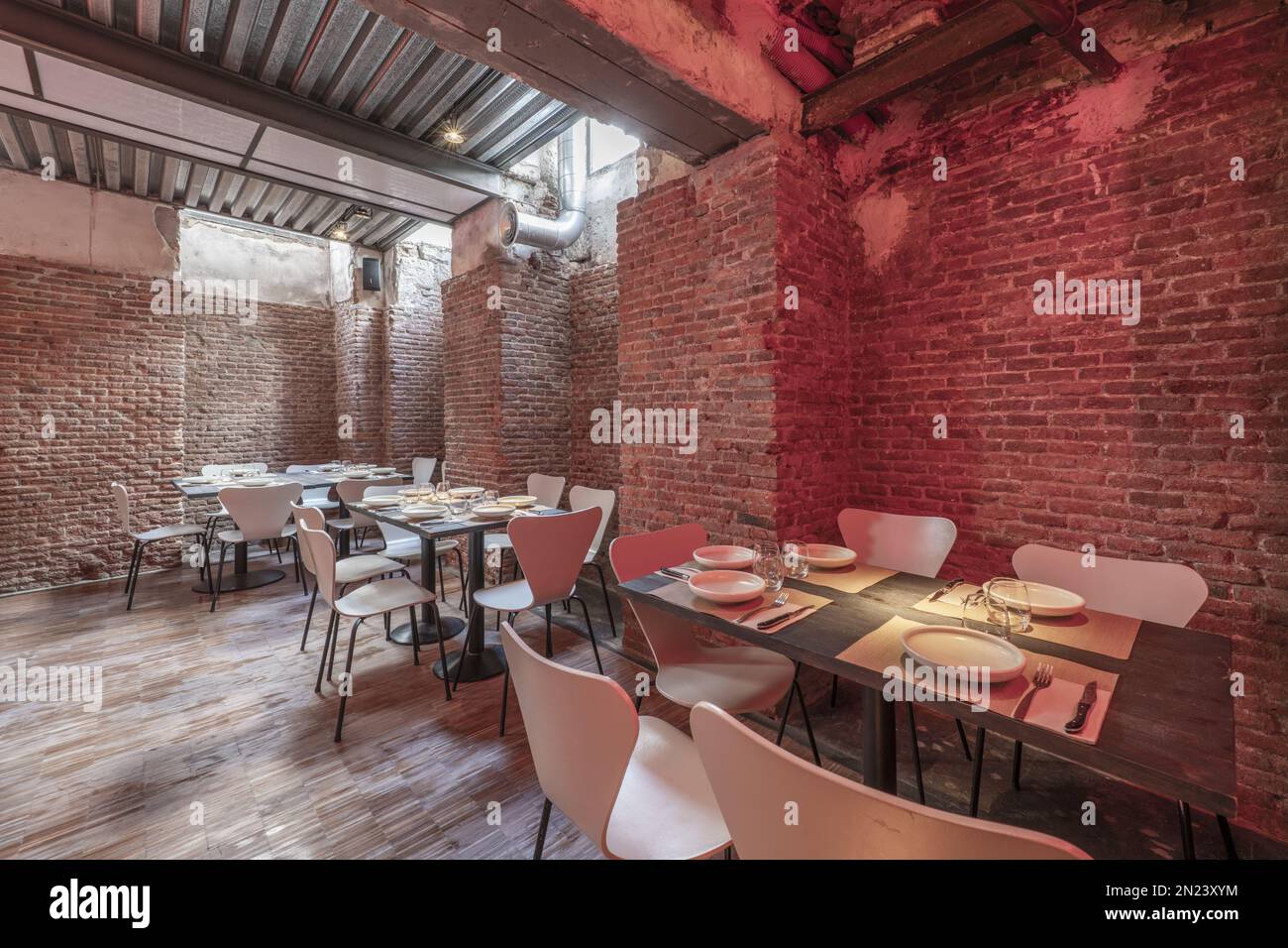 Dining room of a restaurant in a basement with rigid brick and wooden ...