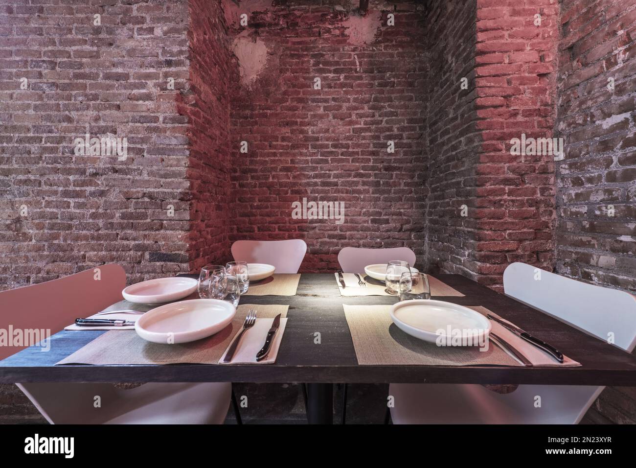 Dining table of a restaurant in a basement with rigid bricks arranged ...