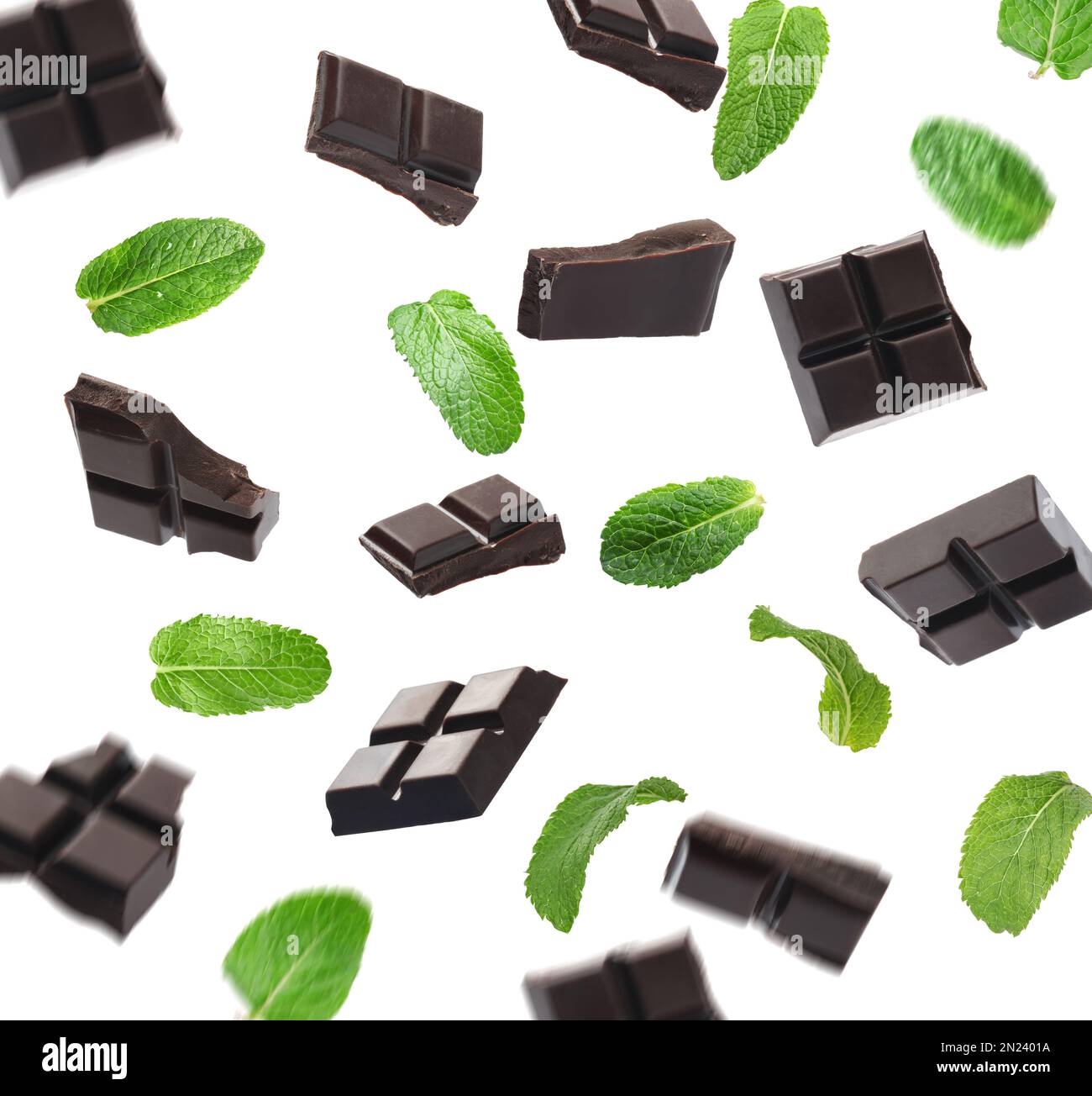 Black chocolate pieces and mint falling on white background Stock Photo ...