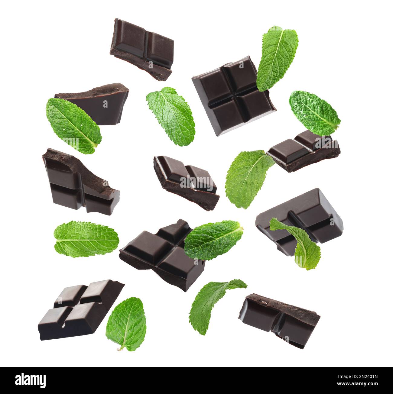 Black chocolate pieces and mint falling on white background Stock Photo ...