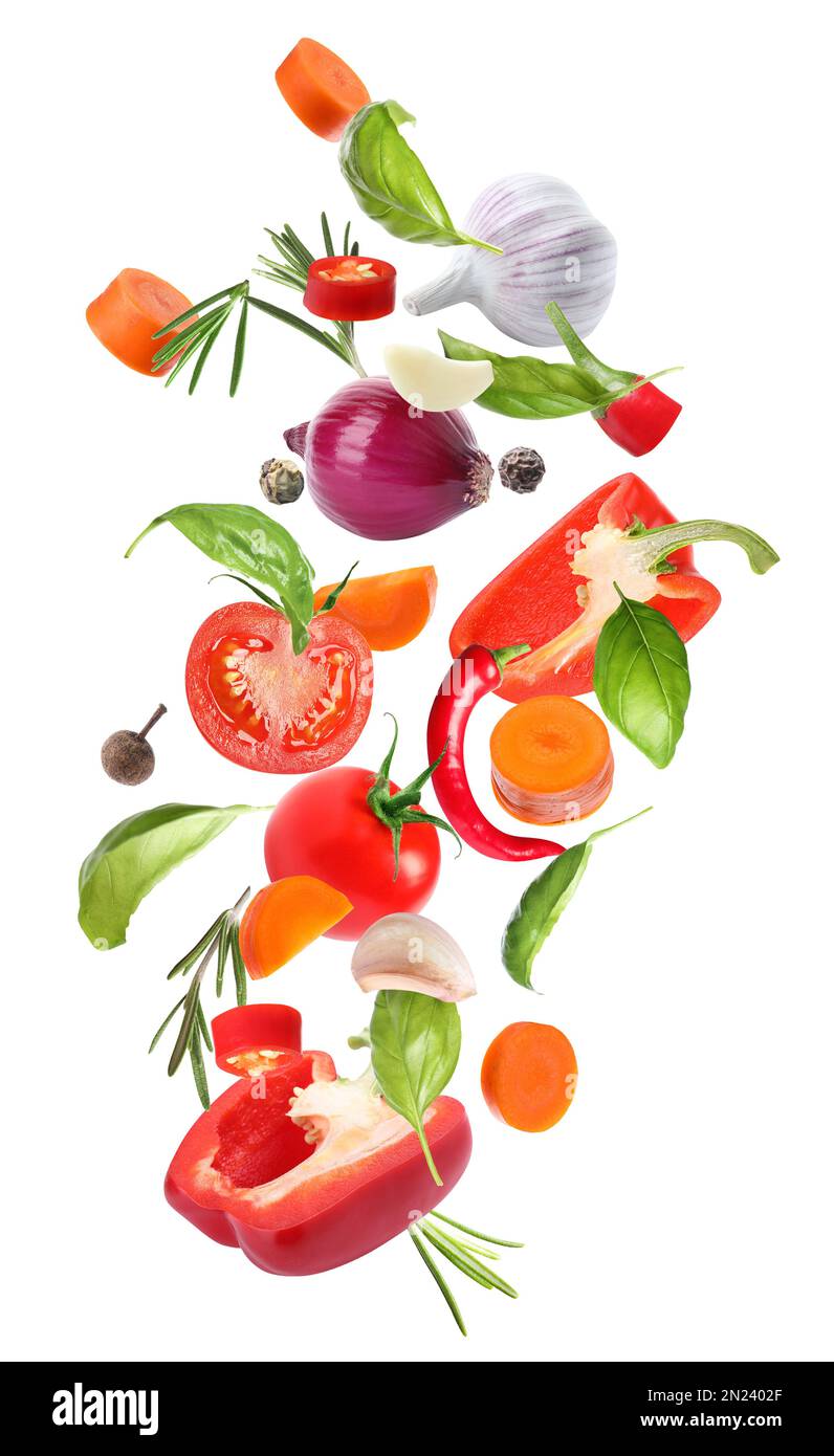 Set of different fresh vegetables and spices falling on white ...
