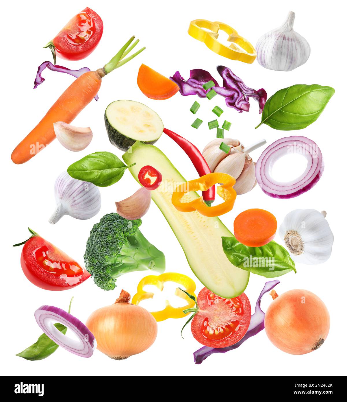 Set of different fresh vegetables and spices falling on white ...