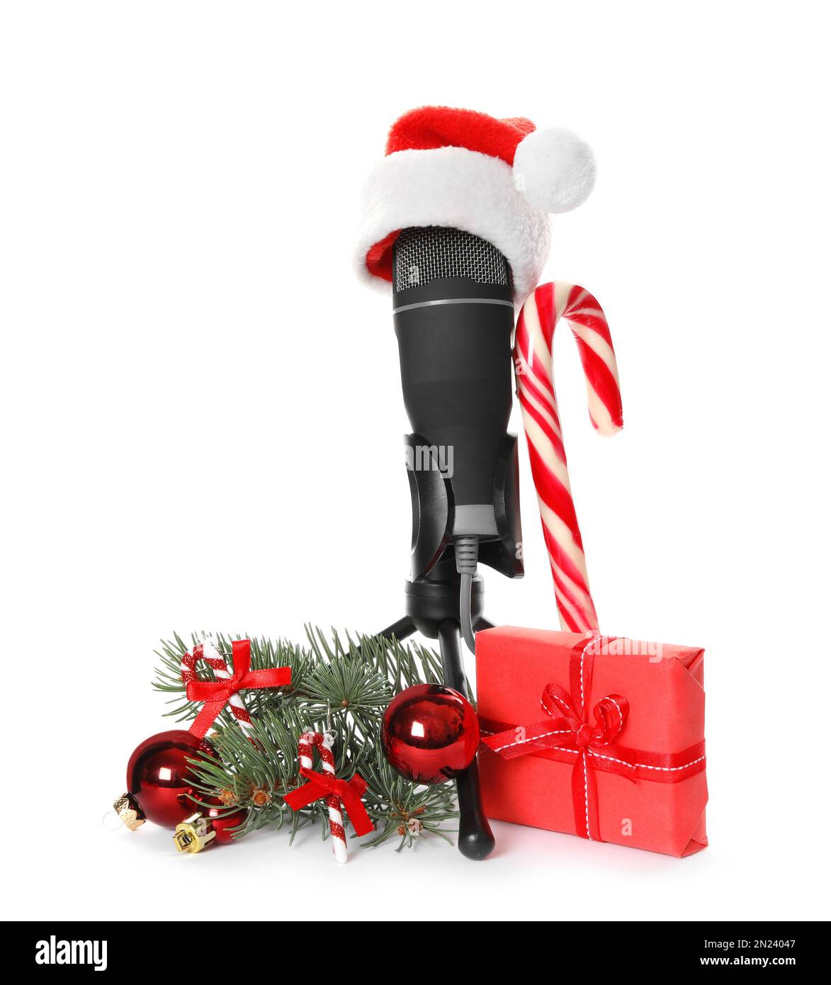 Microphone with Santa hat, gift box, candy cane and festive decor on ...