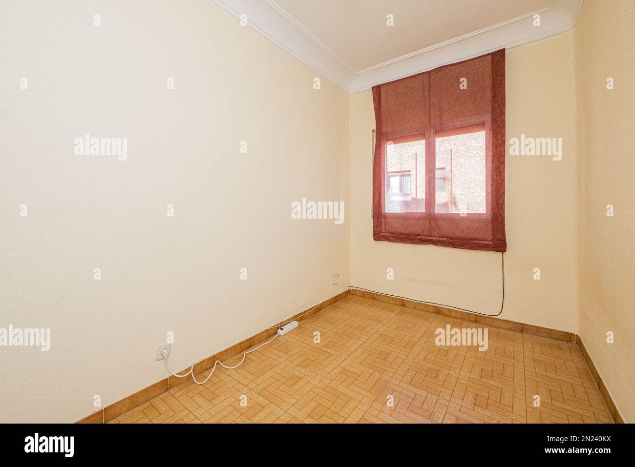 small room with soft cream walls light brown tile floors and window ...