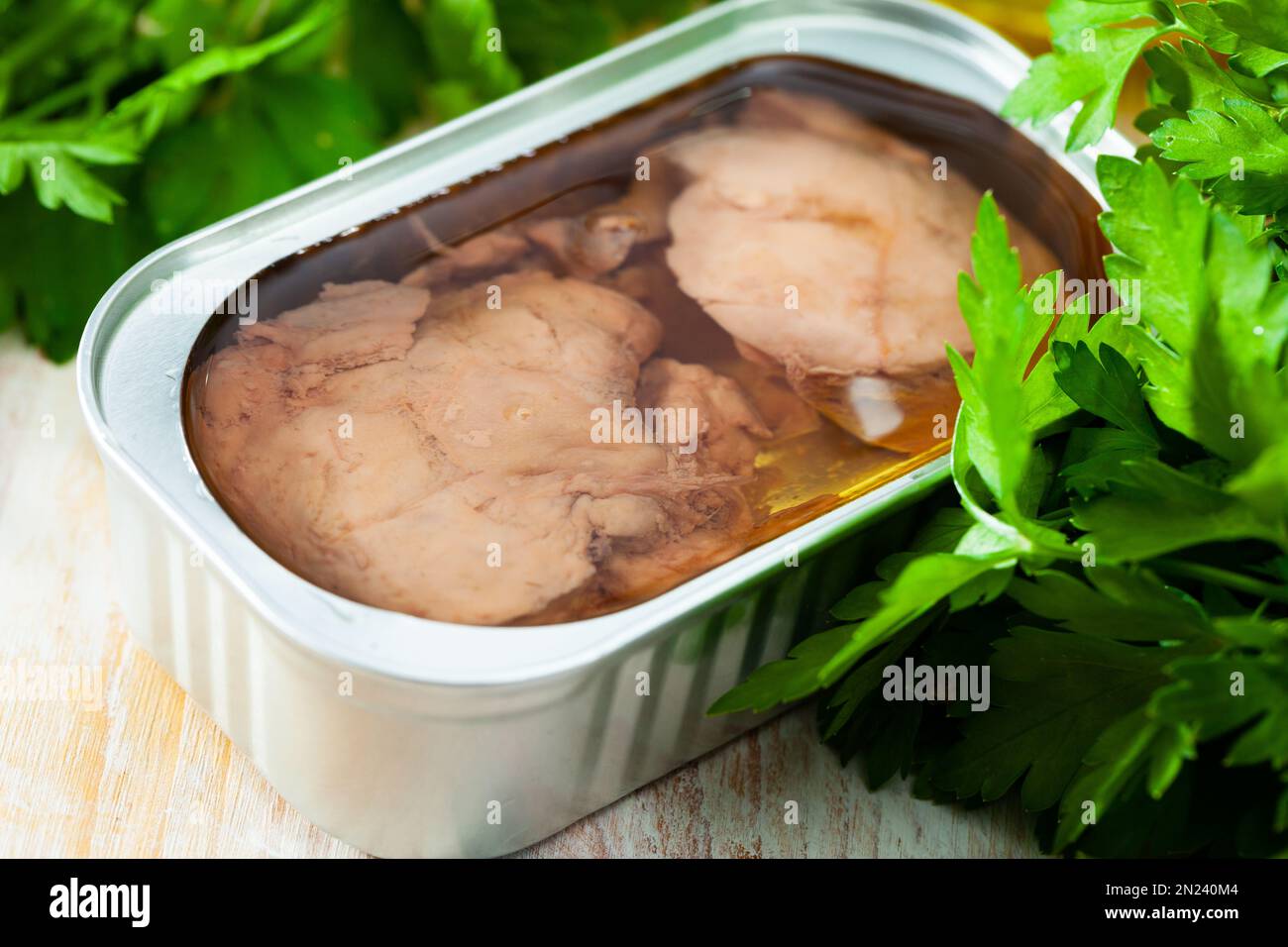 Smoked cod liver in oil with parsley Stock Photo - Alamy