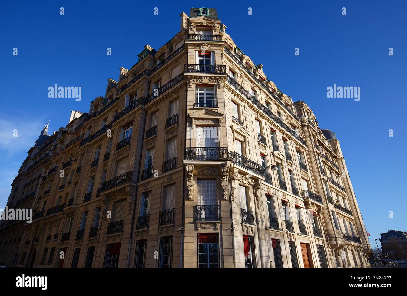 The facade of traditional French house with typical balconies and ...