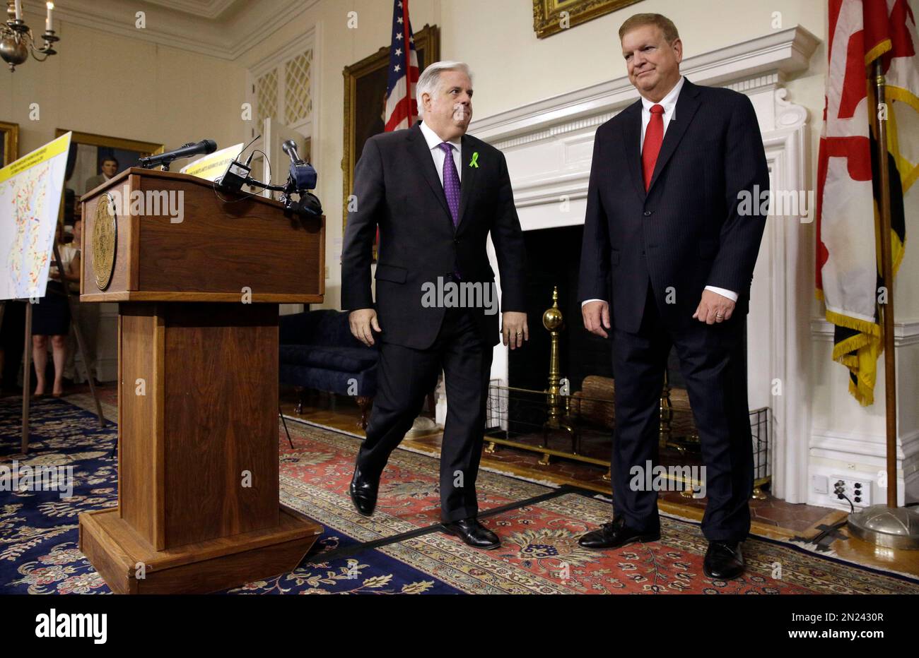 Maryland Gov. Larry Hogan, center, leaves a news conference alongside ...