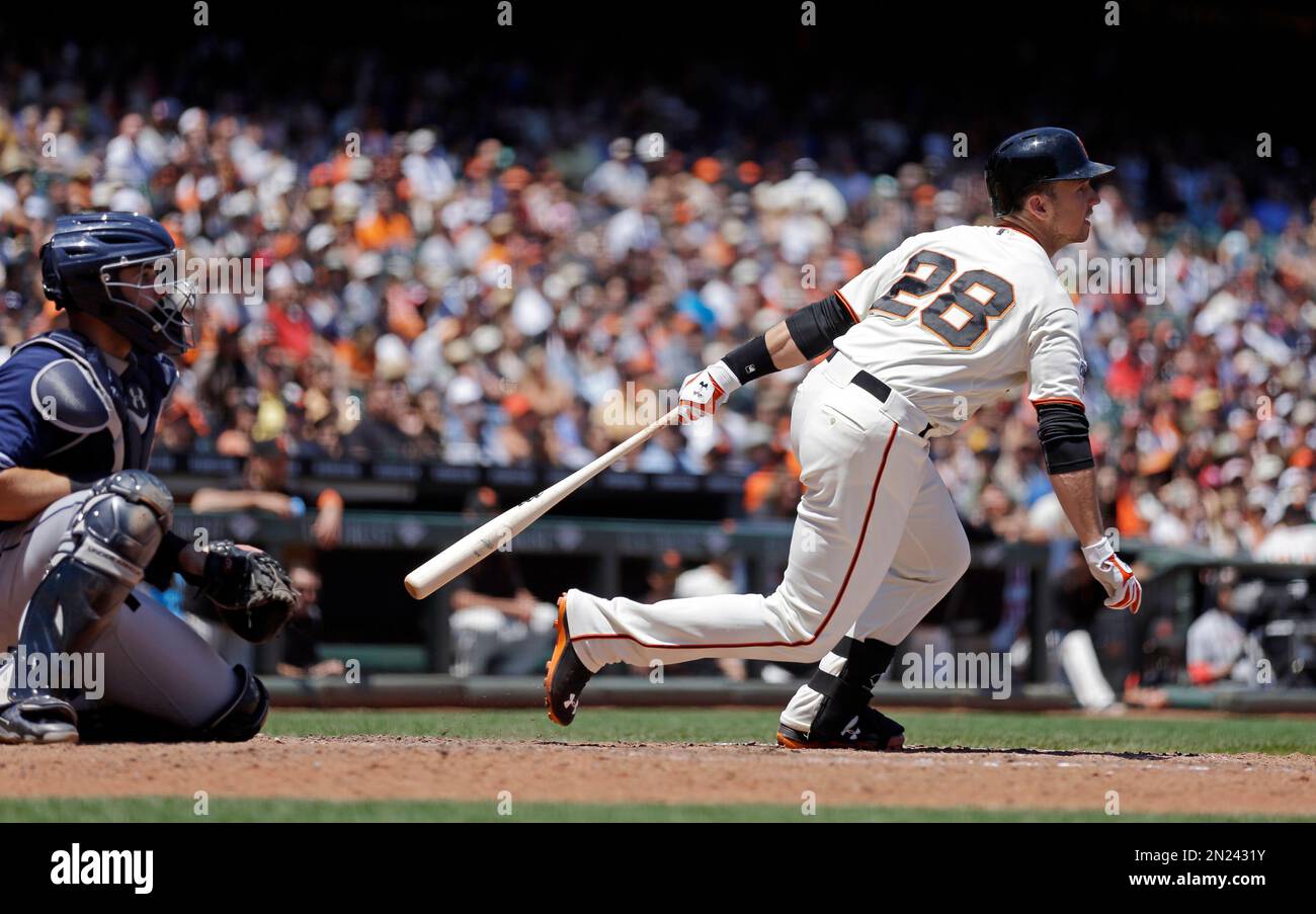 San Francisco Giants' Buster Posey follows through with an RBI single ...