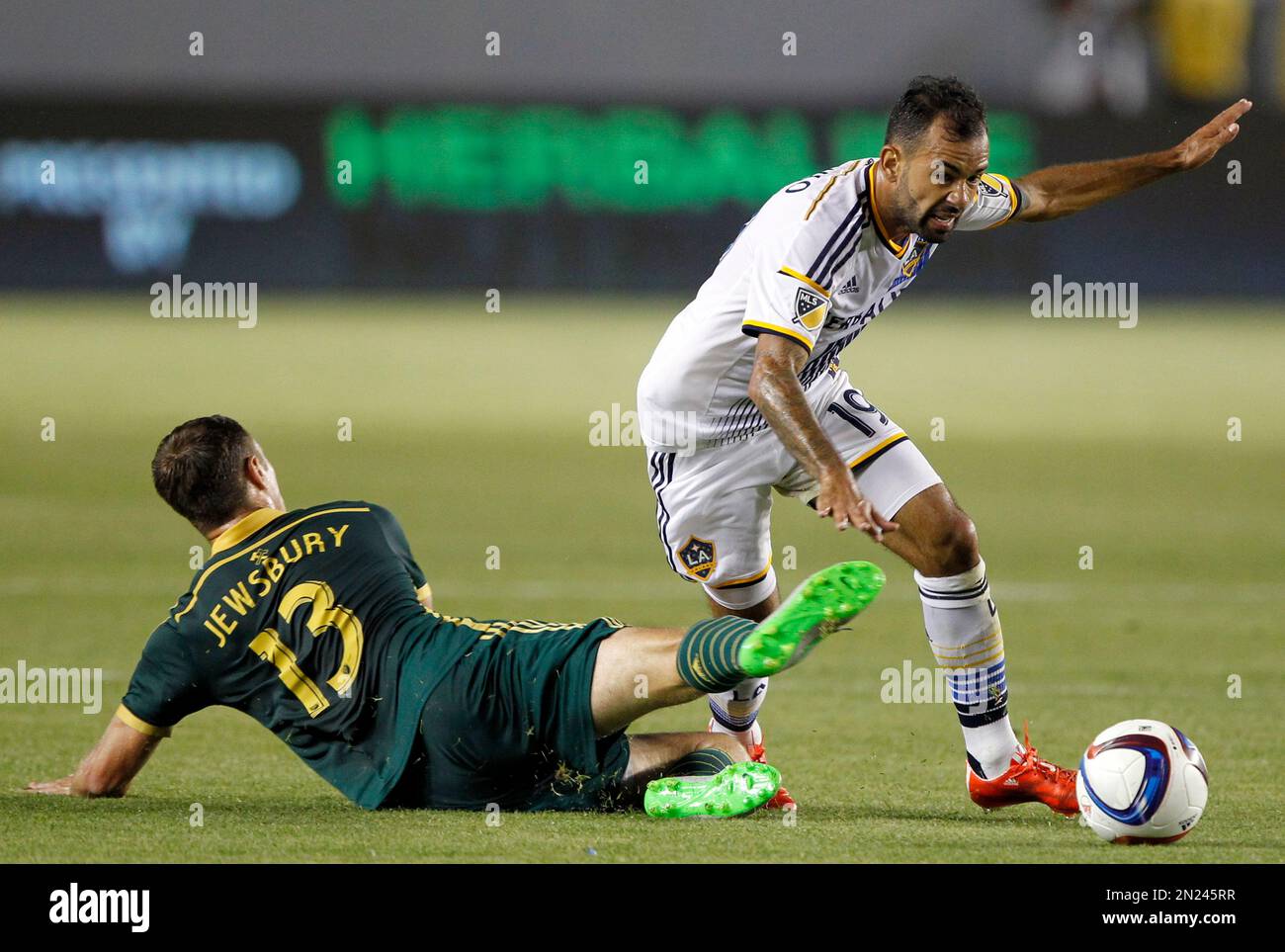 Los Angeles Galaxy midfielder Juninho, right, kicks the ball around the ...