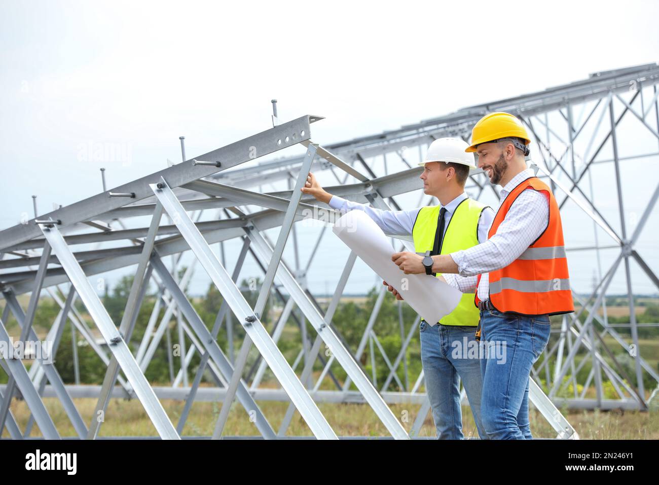 Professional engineers working on installation of electrical substation ...