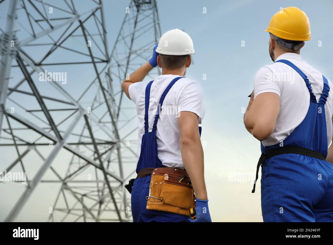 Professional engineers working on installation of electrical substation ...