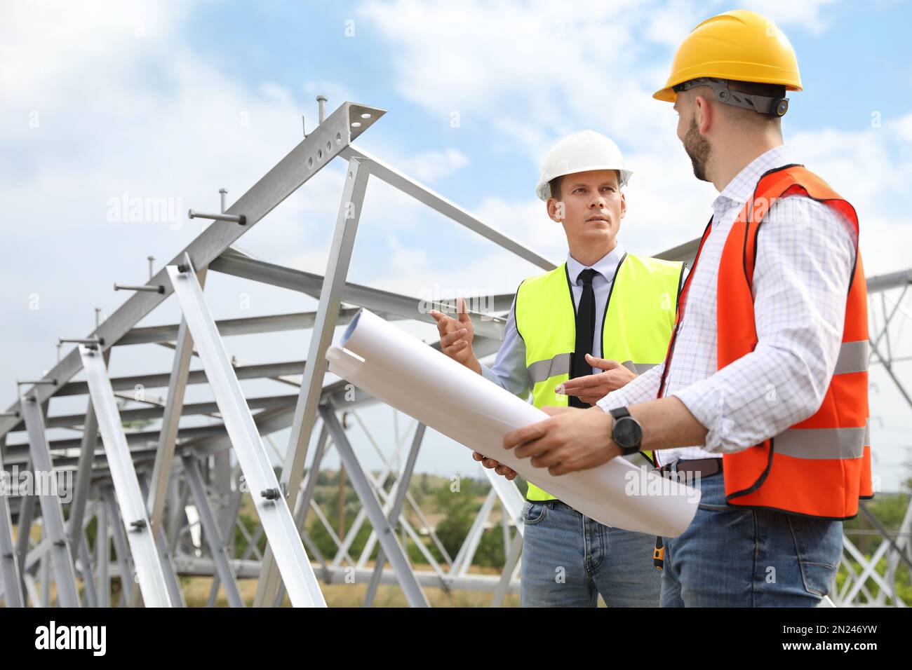 Professional engineers working on installation of electrical substation ...